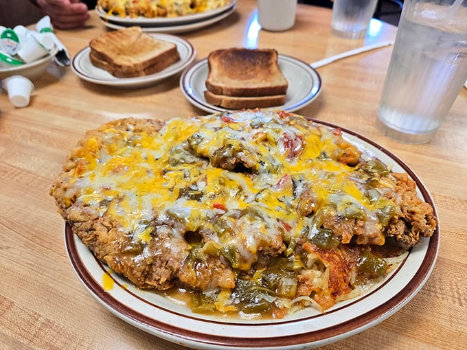 Behold the legendary chicken fried steak in all its glory &ndash; crispy coating, smothered in green chile and cheese. Diet plans come here to die.
