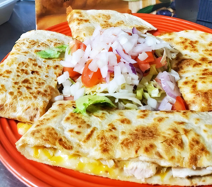 The star of the show: a chicken quesadilla that achieves that perfect balance of crispy exterior and gooey, flavorful interior.