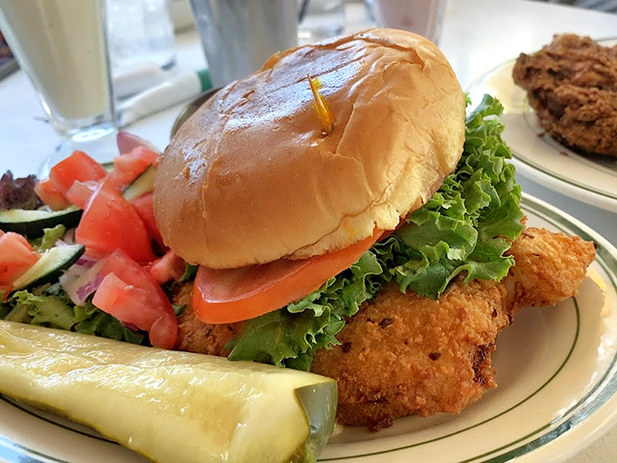 Golden-fried chicken, fresh veggies, and a perfectly toasted bun &ndash; this isn't just a sandwich, it's architecture you can eat.