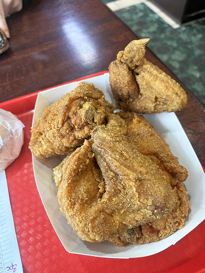 Golden-brown perfection that makes you understand why people plan road trips around chicken. The crunch practically echoes through the photo.