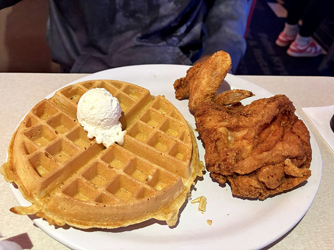Chicken and waffles: where breakfast and dinner collide in perfect harmony. That golden waffle with a scoop of butter is practically winking at you.