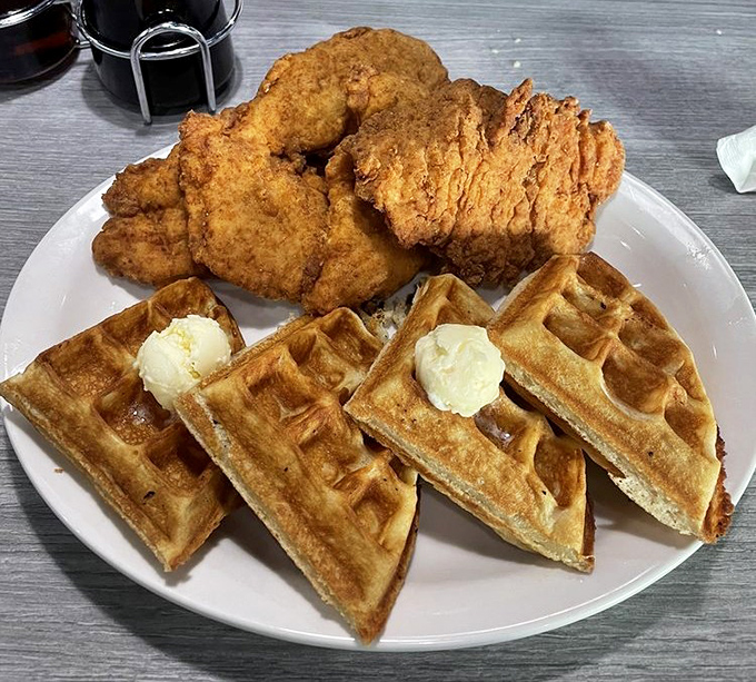 Behold the star attraction: golden waffles supporting perfectly crispy chicken like tasty architectural pillars. This isn't just breakfast&mdash;it's edible engineering.