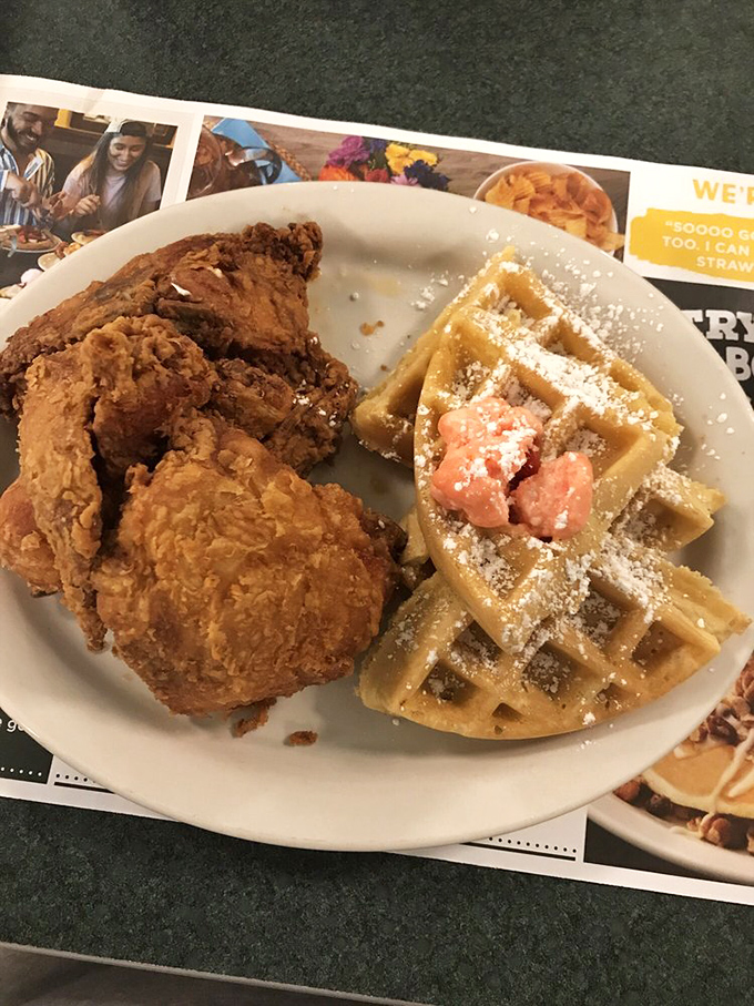 Behold the star attraction: golden-fried chicken alongside a fluffy waffle dusted with powdered sugar. A sweet-savory romance that would make Shakespeare weep.