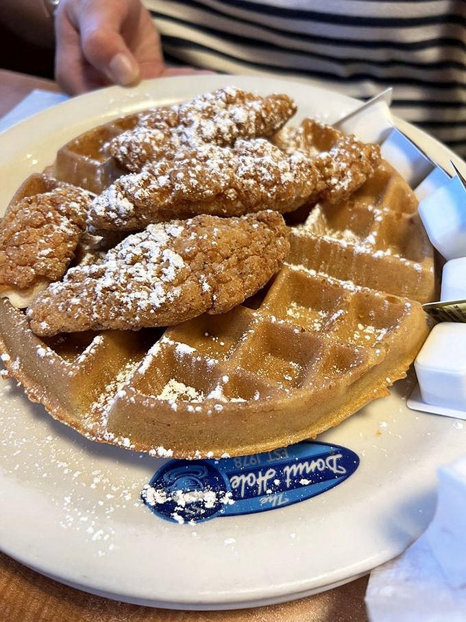 Chicken and waffles: where breakfast and dinner stopped fighting and fell in love. That dusting of powdered sugar is like fairy dust for grown-ups.