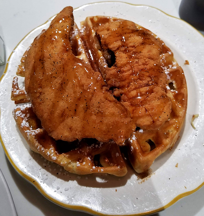 The star of the show: golden-brown waffle cradling perfectly fried chicken, a combination so right it makes you question all other breakfast decisions.