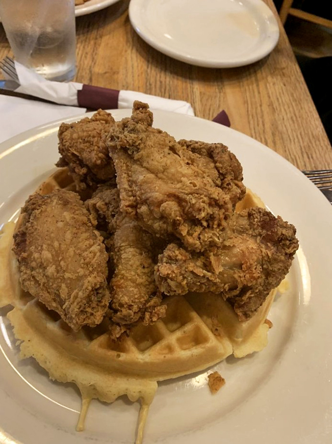 Behold the star attraction: golden-brown fried chicken perched atop a Belgian waffle, a savory-sweet masterpiece that's worth every mile of the drive.