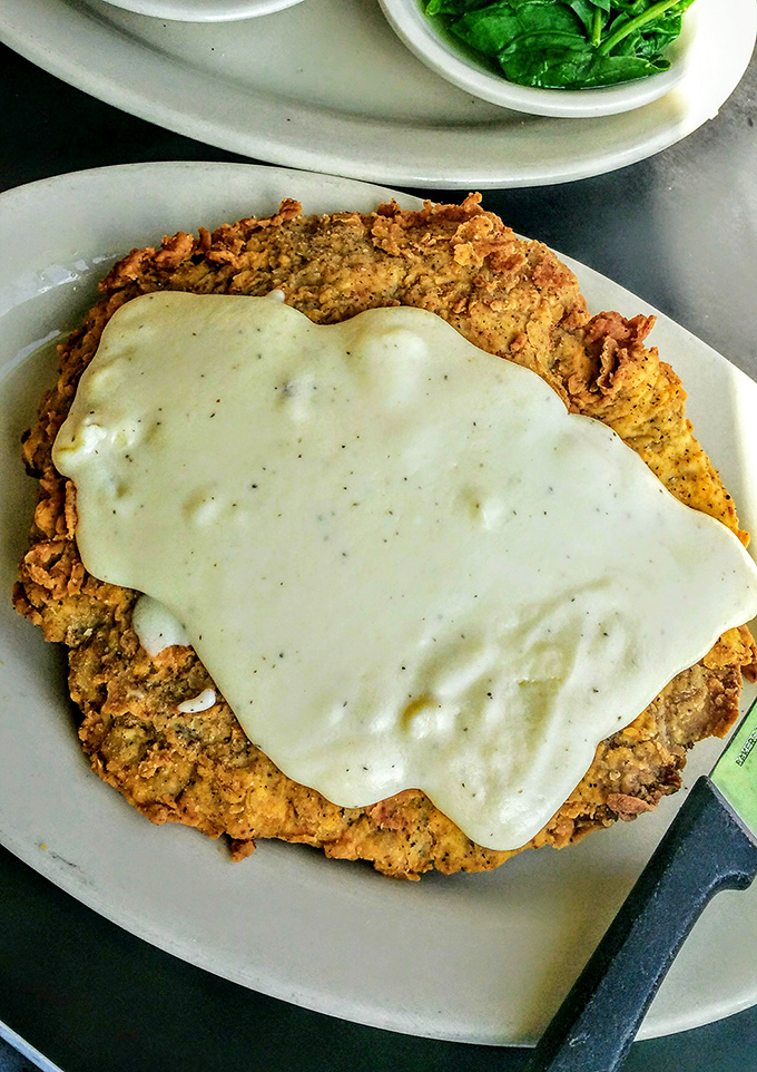 Behold the crown jewel: a chicken fried steak that's practically bursting off the plate, smothered in gravy that's clearly been perfected over decades.