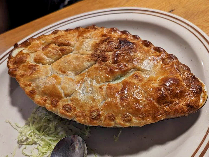 The chicken pot pie's golden dome of pastry practically whispers "break me" as it waits to reveal its steaming, savory treasures.