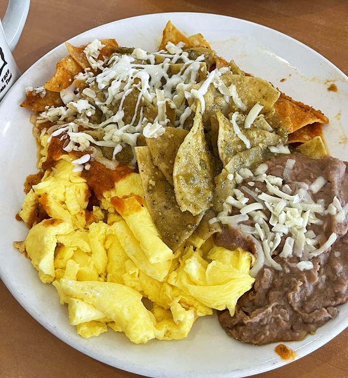Chilaquiles that could end breakfast feuds. Crispy tortilla chips bathed in salsa, topped with melty cheese, alongside fluffy eggs and refried beans&mdash;this plate doesn't just speak, it sings.