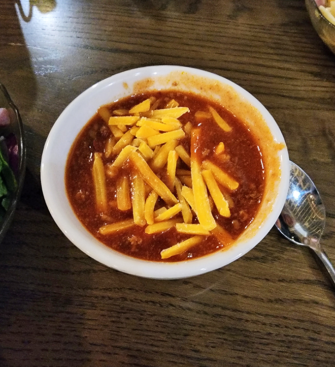 The legendary chili, topped with a crown of shredded cheddar. One spoonful and you'll understand why people cross county lines for this bowl.