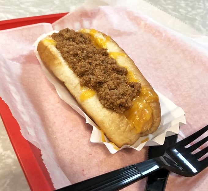 This chili dog isn't trying to impress Instagram—it's too busy preparing to impress your taste buds with that perfect cheese-to-chili ratio.