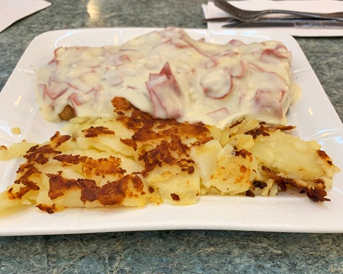 Behold the star attraction: creamy chipped beef cascading over golden toast alongside perfectly crisped home fries that would make your grandmother proud.