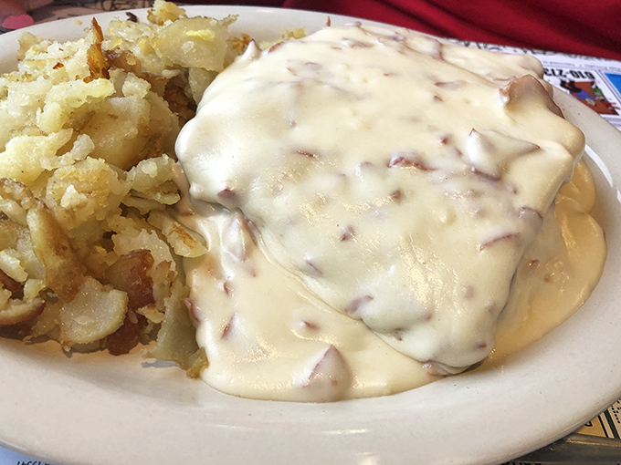 Behold the creamed chipped beef—affectionately known by less polite names to military veterans—smothering everything in its path like a delicious beige avalanche.