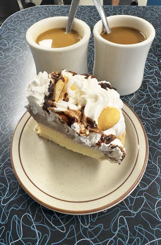 This isn't just pie &ndash; it's a towering monument to dessert perfection, where banana cream and chocolate unite with whipped cream in sweet harmony.