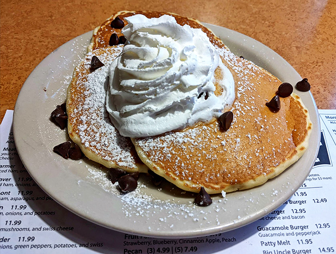 Chocolate chip pancakes crowned with whipped cream—proof that sometimes dessert masquerading as breakfast is exactly what the soul needs.