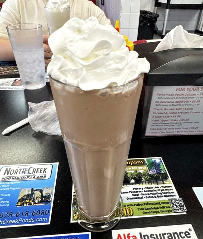 This isn't just a milkshake&mdash;it's a skyscraper of dairy delight topped with a cloud of whipped cream that demands respect.