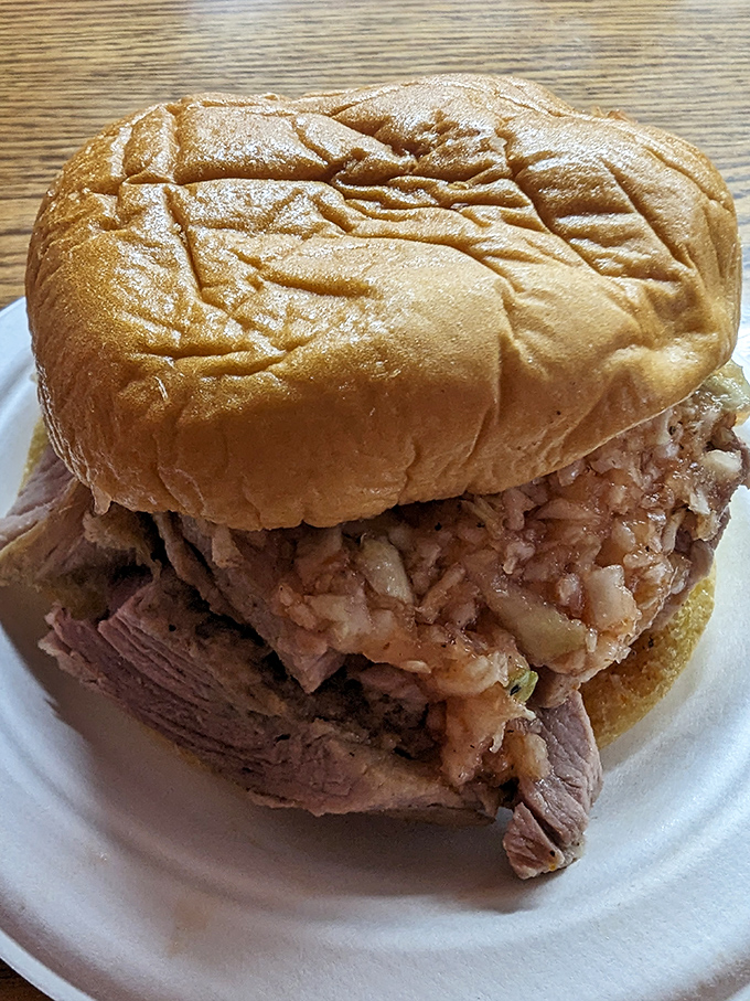 The star of the show in all its glory&mdash;tender chopped pork piled high on a soft bun. This isn't just a sandwich; it's North Carolina history you can taste.