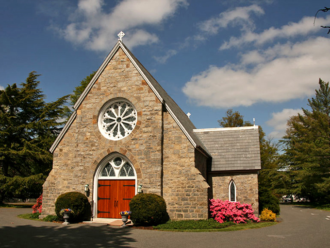 The stone Church of the Holy Trinity stands as Oxford's spiritual anchor, its rose bushes adding splashes of color like nature's own stained glass.
