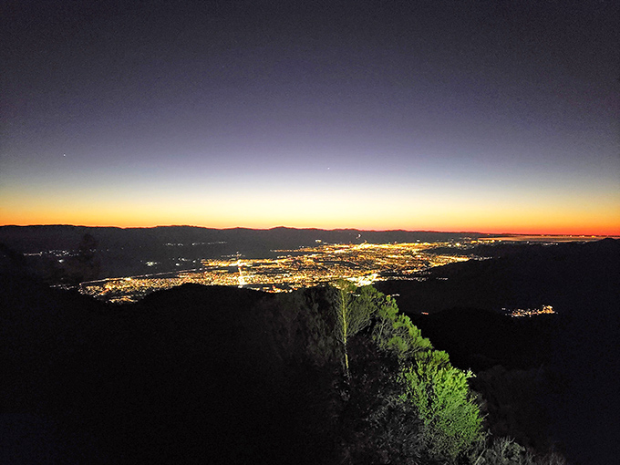 When night falls, the valley lights up like nature's own Vegas show. City lights twinkle below while stars dazzle above—talk about dinner with a view!