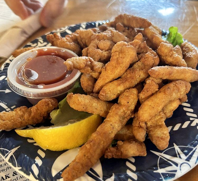 Golden-brown clam strips that crunch like autumn leaves, served with a side of nostalgia and a lemon wedge that's not just a garnish but a necessity for seafood perfection.