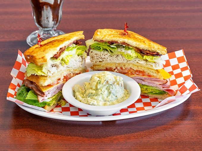 Architecture on a plate! This triple-decker club sandwich doesn't just satisfy hunger&mdash;it conquers it with military precision and mayo-based diplomacy.