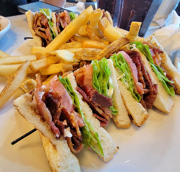 Architecture in sandwich form. Three perfectly toasted bread slices creating the high-rise apartment complex where bacon, lettuce and turkey live in delicious harmony.