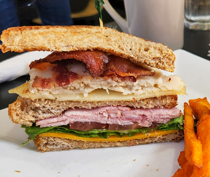 Behold the architectural marvel that is Busy Bee's club sandwich. Three perfectly toasted stories of bread supporting layers of meat, cheese, and veggies in perfect harmony.