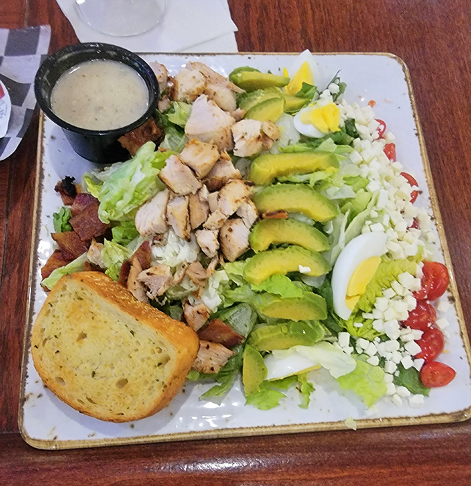 Behold the star attraction &ndash; a Cobb salad arranged with such artistic precision, it's practically the Rembrandt of lunch options, complete with perfect avocado fans.