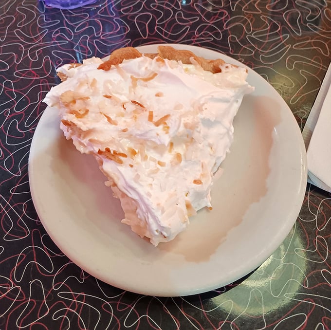 The legendary coconut cream pie in all its glory&mdash;towering meringue, flaky crust, and coconut perfection. Worth driving across state lines for.
