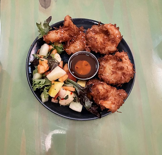 Golden-crusted coconut shrimp that could make a pescatarian weep with joy. The tropical fruit salad adds a refreshing counterpoint.