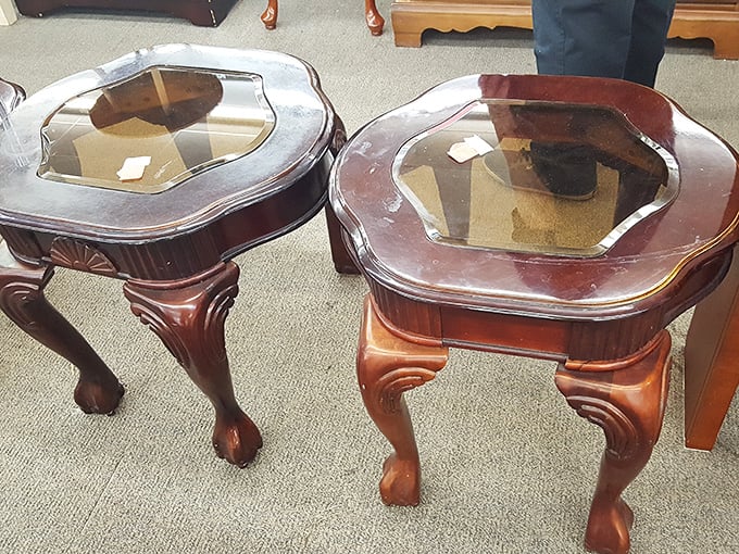 These elegant glass-topped end tables aren't just furniture; they're time travelers from a more ornate decorating era.