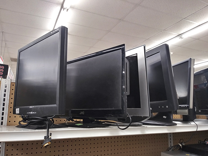Computer monitors lined up like patient soldiers, ready to bring digital life back to your workspace.