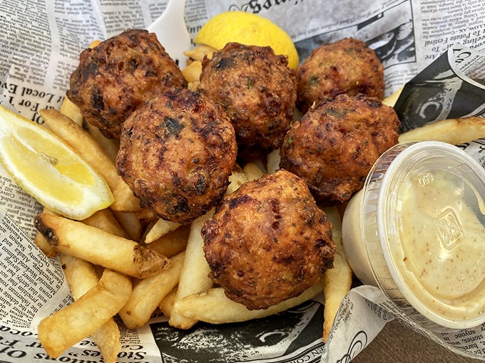 Golden-brown spheres of happiness nestled on a bed of fries. These conch fritters are the perfect marriage of crispy exterior and tender, flavorful interior.
