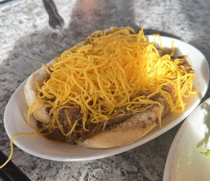 Behold the Cincinnati coney in all its glory&mdash;a hot dog practically wearing a yellow cheese toupee that would make any food lover weak at the knees.