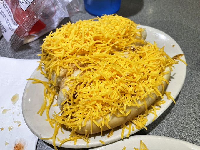 Behold the famous Coney dog, buried under an avalanche of finely shredded cheddar that would make a snowplow envious.