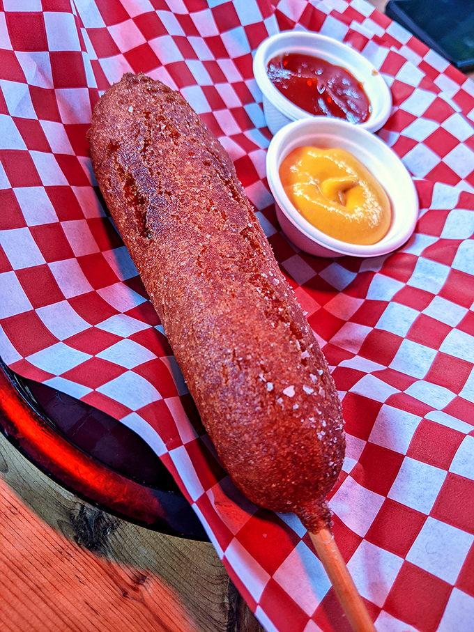 Not all heroes wear capes; some come skewered on sticks. This golden-brown corn dog with house-made sauces might just ruin carnival food for you forever.