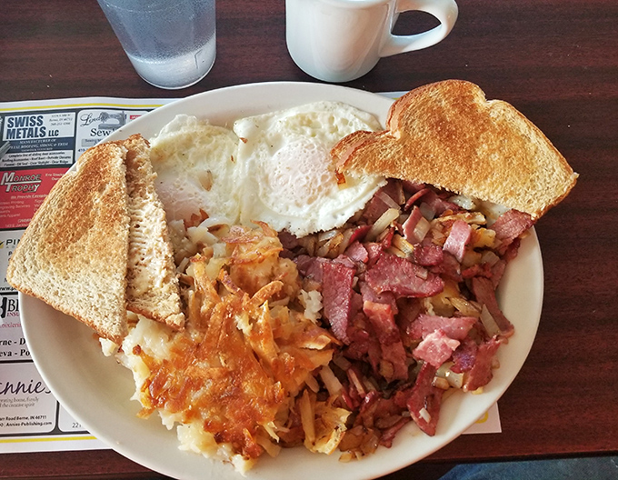 The holy trinity of breakfast perfection: corned beef hash with chunks you can actually identify, eggs with yolks ready to burst, and hash browns that mean business.