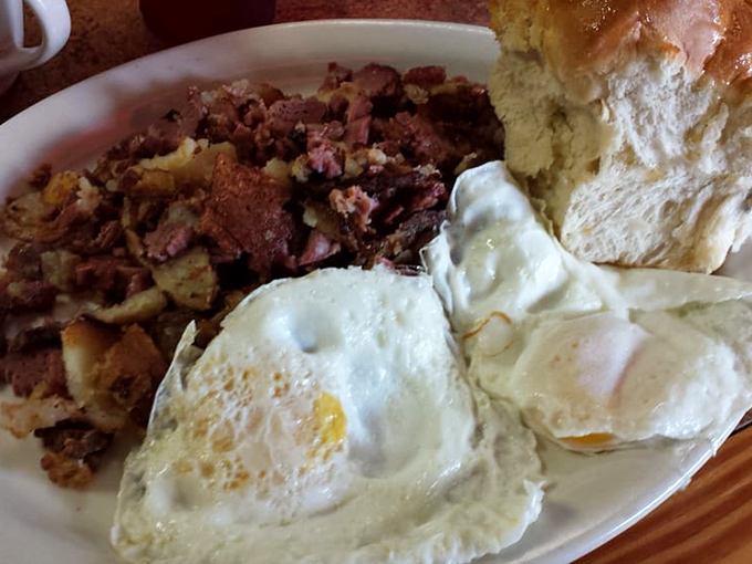Corned beef hash and eggs that would make your grandmother weep with joy, served with a biscuit that deserves its own fan club.