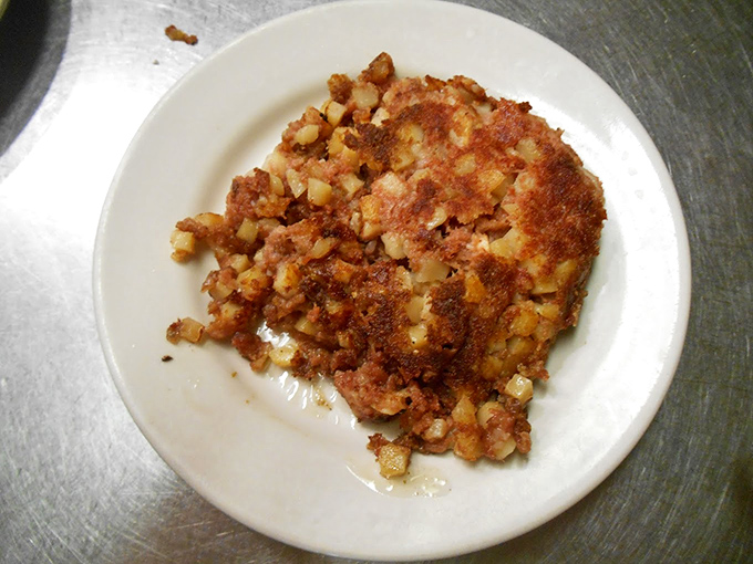 Behold the star attraction: corned beef hash with that perfect crispy-to-tender ratio that makes breakfast philosophers question why they'd eat anything else.