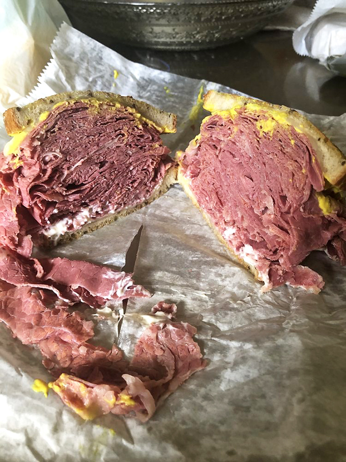 Behold the star attraction: layers of hand-sliced corned beef stacked so high between rye bread, it practically requires unhinging your jaw.