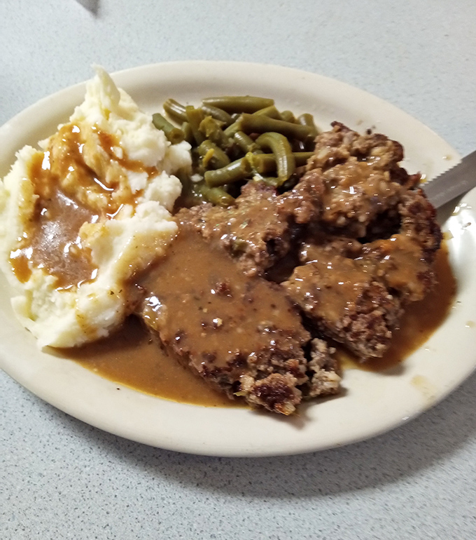 Country fried steak that would make your grandmother weep with joy, smothered in gravy that deserves its own fan club.