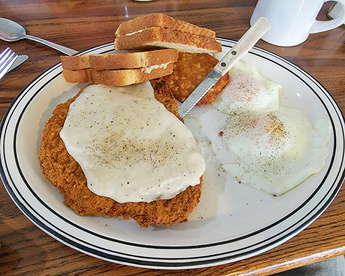 Country fried steak that's achieved the holy trinity of diner perfection: crispy exterior, tender interior, and gravy that should be considered a national treasure.