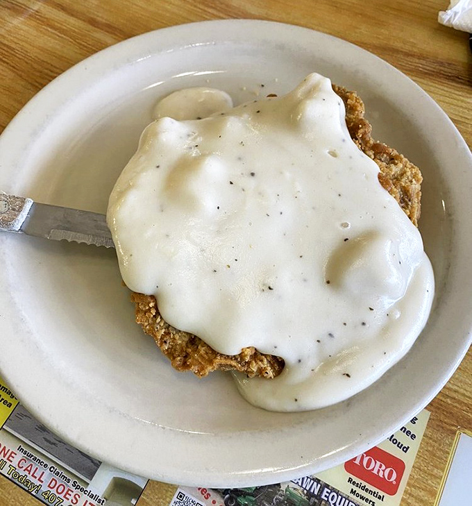 Behold the star attraction: country fried steak smothered in peppery white gravy. Poetry on a plate, Florida-style.