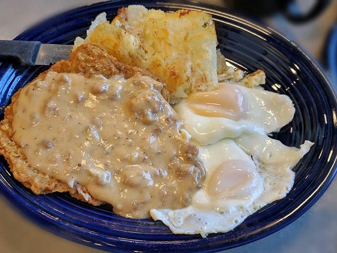 Country fried steak with gravy that cascades like a savory waterfall. This plate doesn't just speak comfort food&mdash;it sings it.