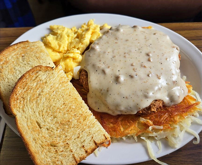 Behold the star of our show: country fried steak swimming in peppery gravy with a supporting cast of golden hash browns and toast.