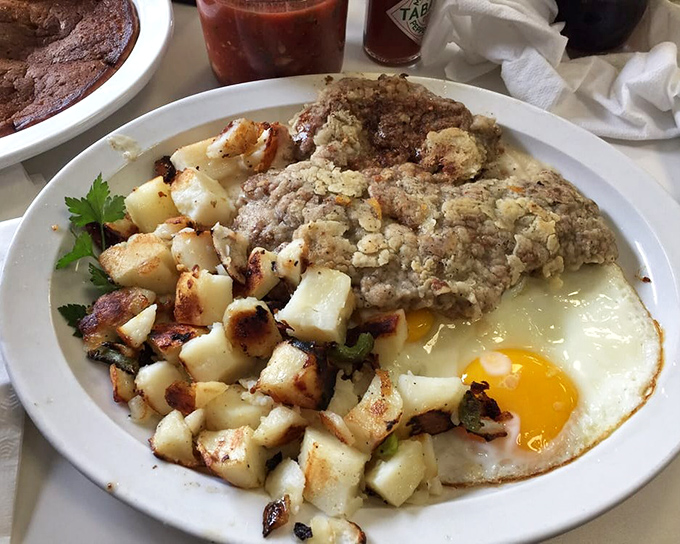 Country fried steak that's been breaded and fried until golden, then smothered in gravy—comfort food that hugs you from the inside out.