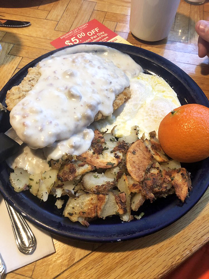 The legendary country fried steak arrives like breakfast royalty&mdash;crispy, tender, and swimming in pepper-speckled gravy that deserves its own fan club.
