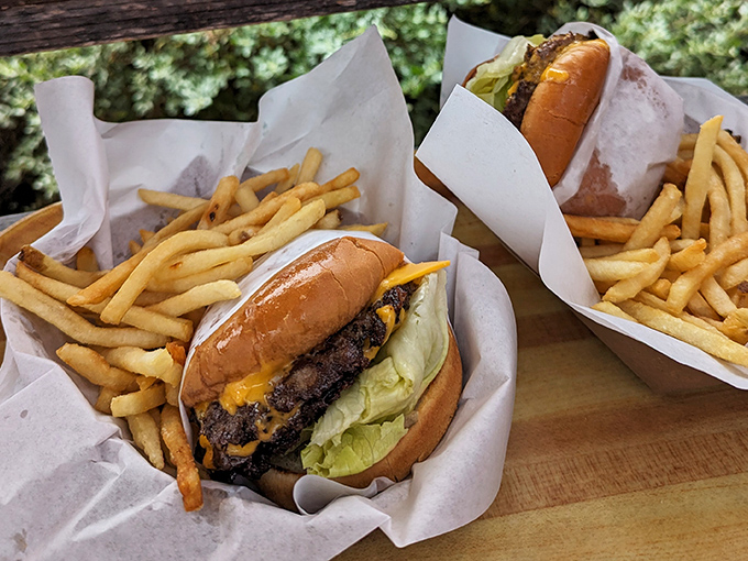 Behold the Cove Burger in its natural habitat&mdash;surrounded by golden fries and wrapped in paper that will soon bear the marks of culinary enthusiasm.