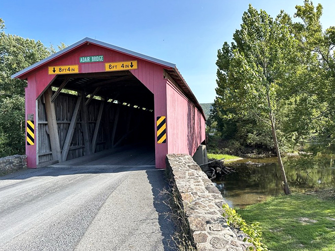 Where country roads and engineering brilliance meet. The bridge's approach offers a perfect preview of the 157-foot journey across Sherman's Creek.