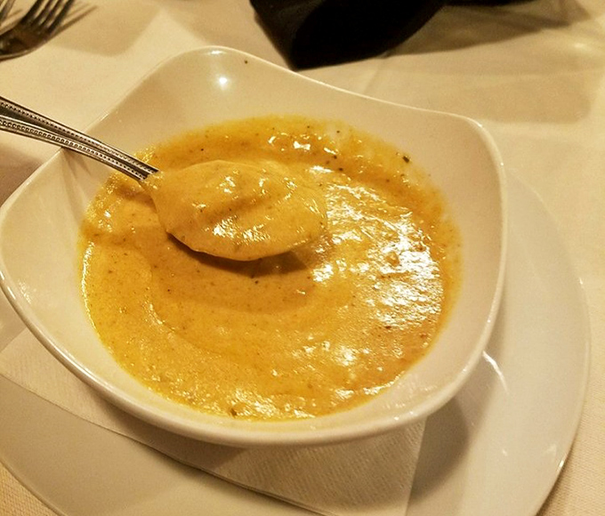 The legendary crab bisque in all its amber glory. One spoonful and you'll understand why people cross county lines for this liquid gold.